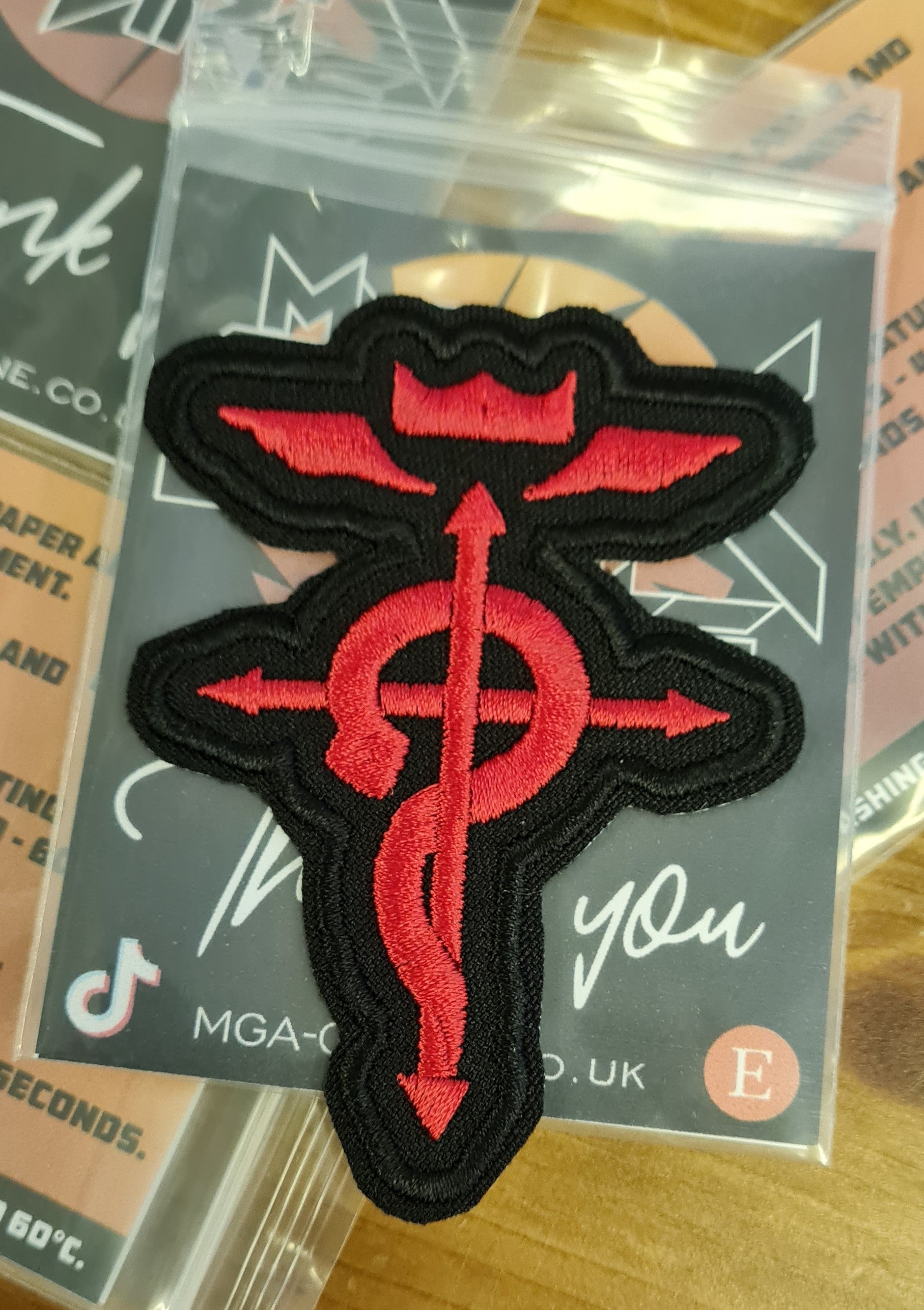 FMA - Flamel Logo Embroidered Patch – MGA Online